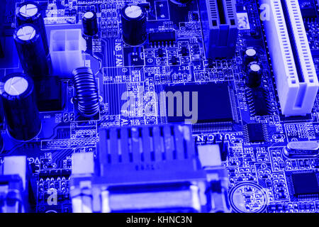 Integrated semiconductor microchip on blue circuit board representative ...