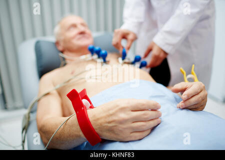 Female patient having ECG electrocardiogram in hospital. Woman patient ...