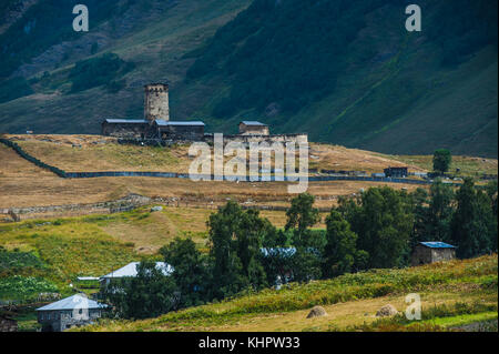 Village Ushguli landscape with massive rocky mountains Bezengi wall ...