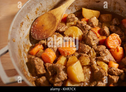 A pot of traditional American style beef stew with potatoes and carrots ...