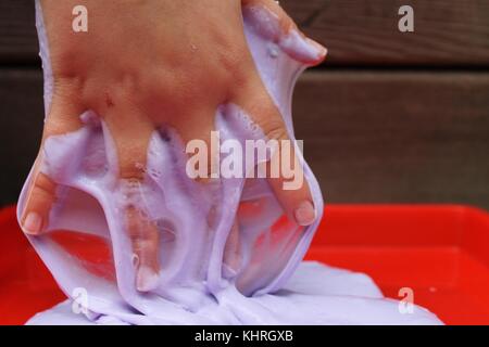 closeup of child's hands playing with slime Stock Photo - Alamy