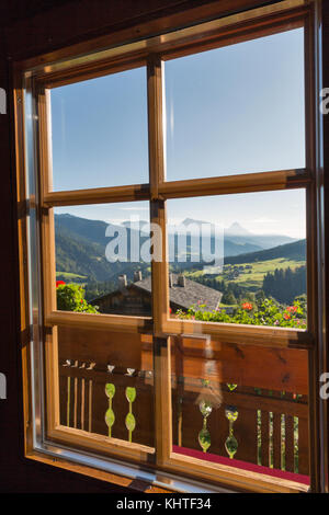 View through window towards the surrounding green mountains and Alpine ...