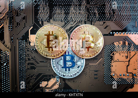 Golden Bitcoin coins on Motherboard, miner with circuit board, pool ...