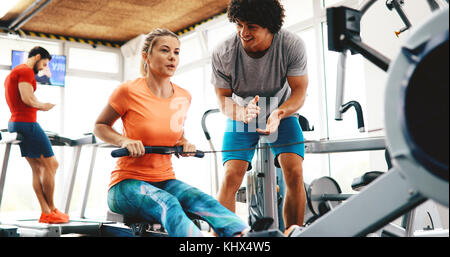Personal trainer giving instructions in gym Stock Photo - Alamy