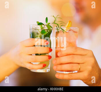 Two cocktail glasses in man and woman hand. Close up Stock Photo - Alamy