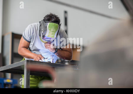 Man welding in bodywork repair shop Stock Photo - Alamy