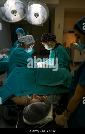 Doctors perform a Cesarean section of an operating room in a maternity ...
