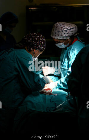 Doctors perform a Cesarean section of an operating room in a maternity ...