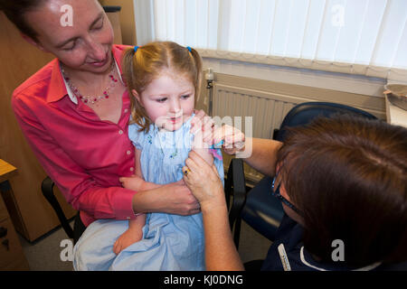 Nurse giving NHS 4-in-1 pre-school booster & MMR second dose ...