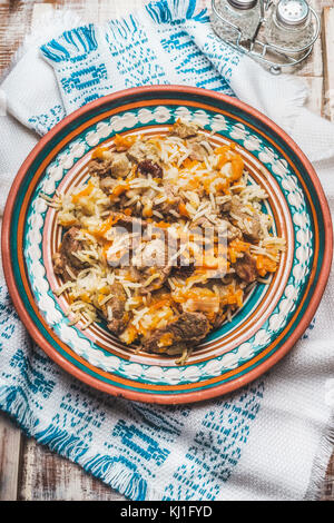 Pilaf on white plate over blue stone table. Healthy diet food Stock ...