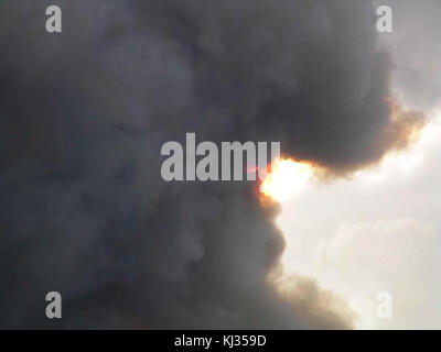 Sun trought smoke on sky Stock Photo - Alamy