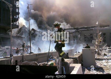 Fire fighters amid smoking rubble following September 11th terrorist ...