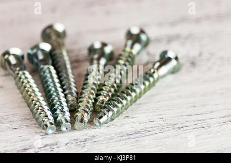 screws macro photo. Long Iron or metal screw nails on blue backgraund ...