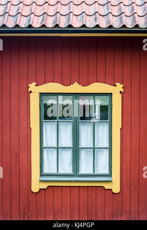 A typical old-fashioned Swedish window decorated with white curtains ...