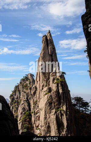 Rolling hills and sharp mountain peaks create a dramatic contrast ...