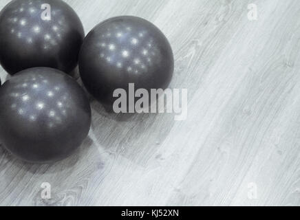 Medium size black balls for pilates exercises Stock Photo - Alamy