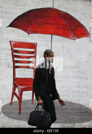 A man walks past a mural in the Bogside area of Londonderry, Northern ...