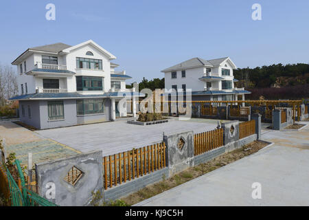 Rizhao, China's Shandong Province. 21st Mar, 2016. People walk past a ...