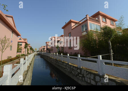Rizhao, China's Shandong Province. 21st Mar, 2016. People walk past a ...