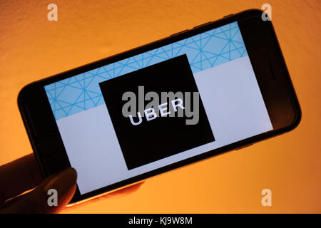 The Uber app is seen on an iPhone near a driver's vehicle in Vancouver ...