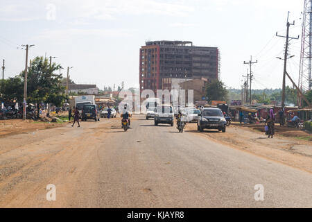 Main road running through Bondo town in Western Kenya with people and ...
