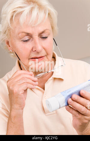 Woman reading ingredients on package, Winnipeg, Canada Stock Photo - Alamy