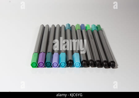Fine line coloured pens on red background Stock Photo - Alamy