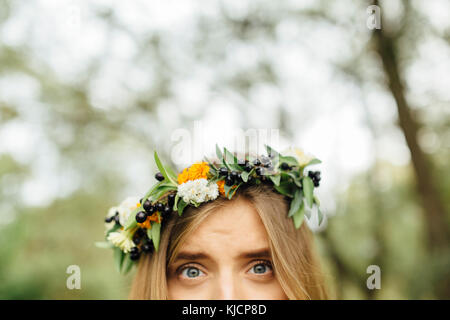 Middle Eastern woman wearing flower crown near river Stock Photo - Alamy