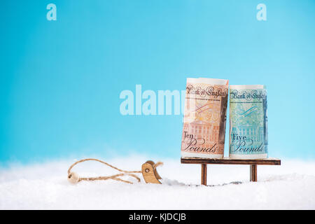 British pounds on snow sledge Stock Photo - Alamy