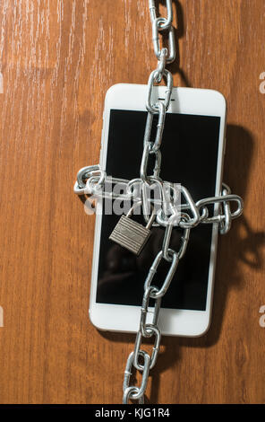 Smart phone and chains. Padlock Stock Photo - Alamy