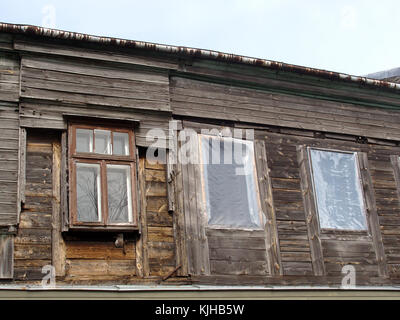 Wooden floor, beams and roof boards with stacked pink fiberglass ...