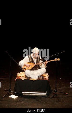 Albanian sufi musician Enris Qinami playing the sharki on stage. France ...