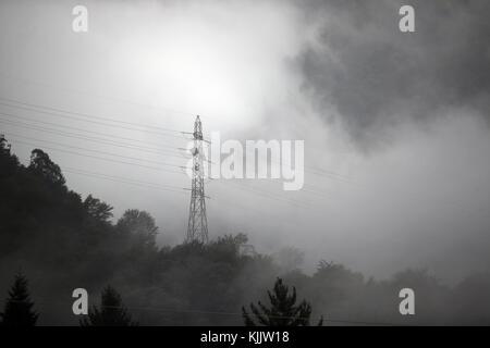 High voltage powerlines in fog Photographed in Finland Stock Photo - Alamy