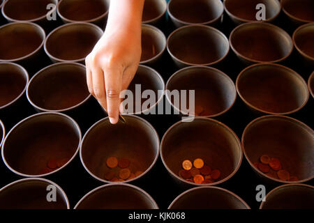 Child offering coins in Wat Suandok, Chiang Mai, Thailand, Southeast ...