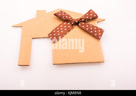 Little house shape cut out of paper on a canvas background Stock Photo ...