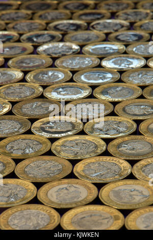 a large number of coins lying together, metal coins of different ...