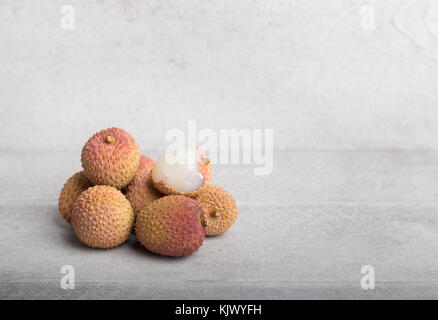 lychee fruit on a grey stone background Stock Photo - Alamy