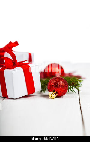 Christmas gifts with red bows, spruce branch and balls. Beautiful still ...