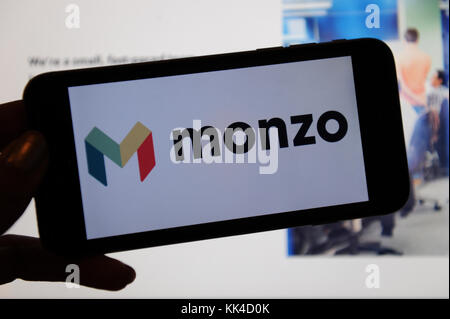 Monzo logo and website seen on phone and a computer screen Stock Photo ...