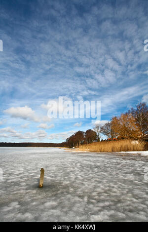 Iced lake in sun in denmark in winter Stock Photo - Alamy