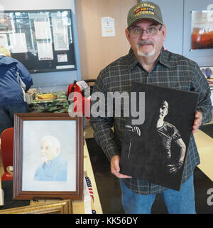 Army Veteran John Sitman shows off a painting of his late Army Veteran ...