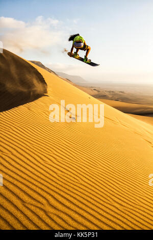 Sandboarding on Caramucho dunes, in Atacama Desert. Iquique, Tarapaca ...