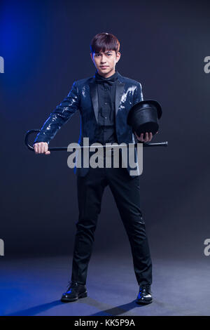 Full length portrait of a magician performing a magic trick with ...