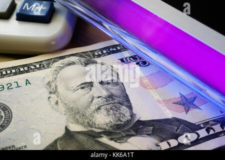 Dollar bill in uv light, fraud check Stock Photo - Alamy
