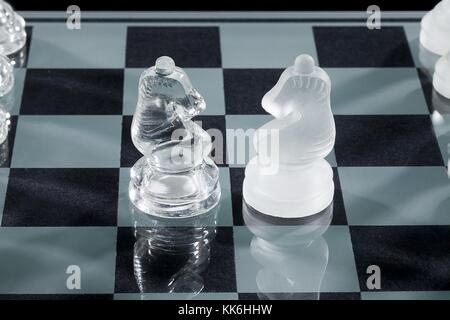Two chess knights facing each other Stock Photo - Alamy
