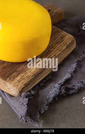 Round gouda cheese. Dark background Stock Photo - Alamy