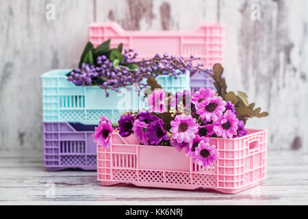 Colorful mini plastic cases with colorful flowers with copy space on ...