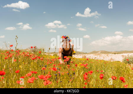 beautiful girl in poppy field enjoys the beauty and aromas Stock Photo ...