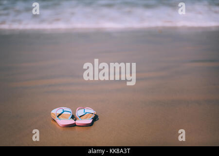 Trendy slippers on white sandy ocean beach Stock Photo - Alamy