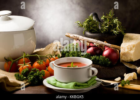 photo ofo delicious tomato soup with vegetables on wooden table Stock ...